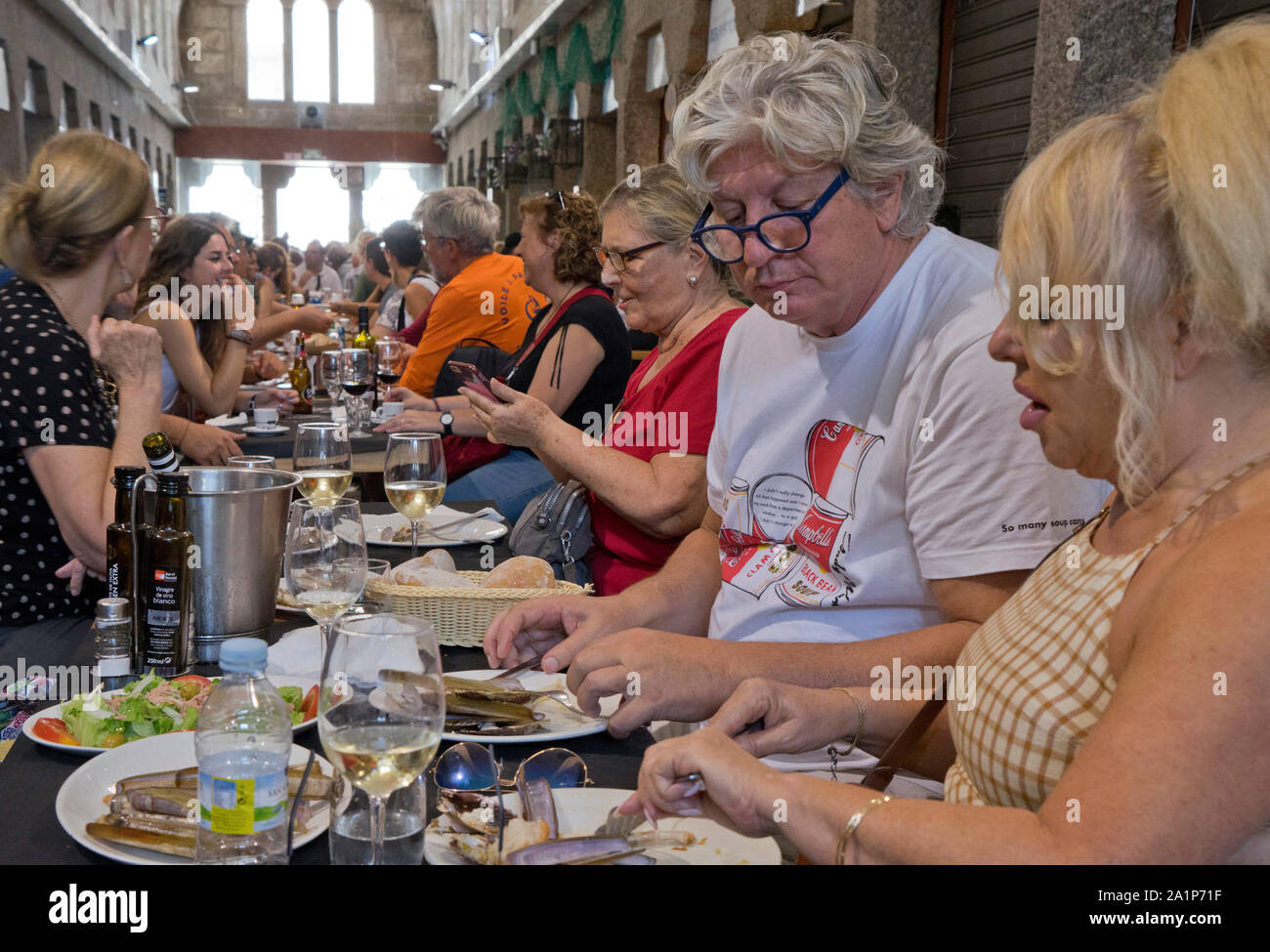 People eating seafood in the market in Santiago de Compostela, Galicia ...