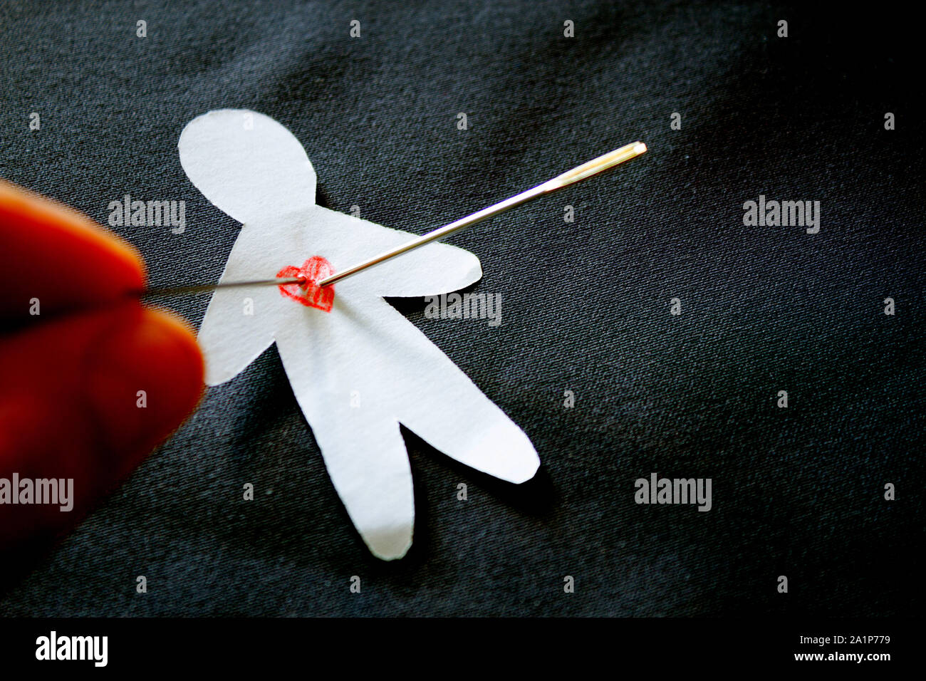 Paper voodoo doll on dark background with needles Stock Photo - Alamy
