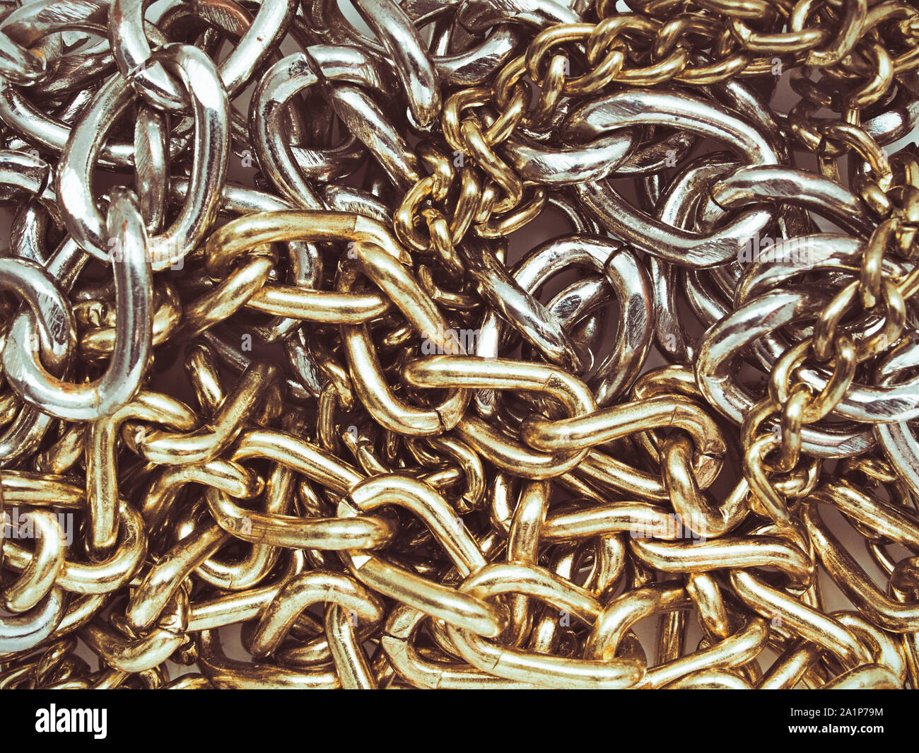 Tangled gold and silver chains close up. Textured metallic background ...