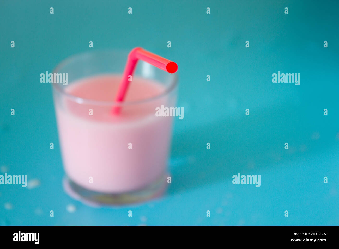 Pink smoothies on blue background with copy space Stock Photo - Alamy