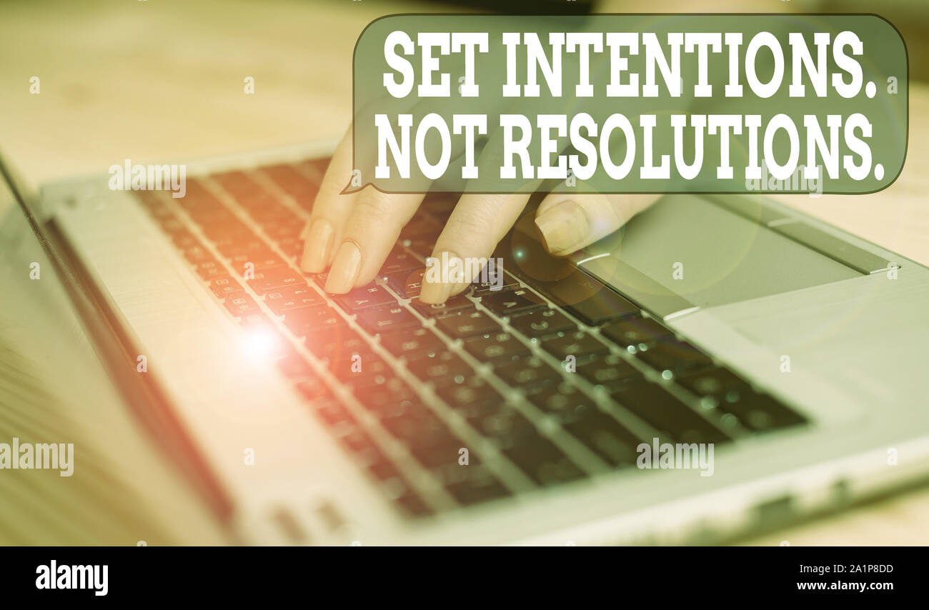 Writing note showing Set Intentions Not Resolutions. Business concept ...