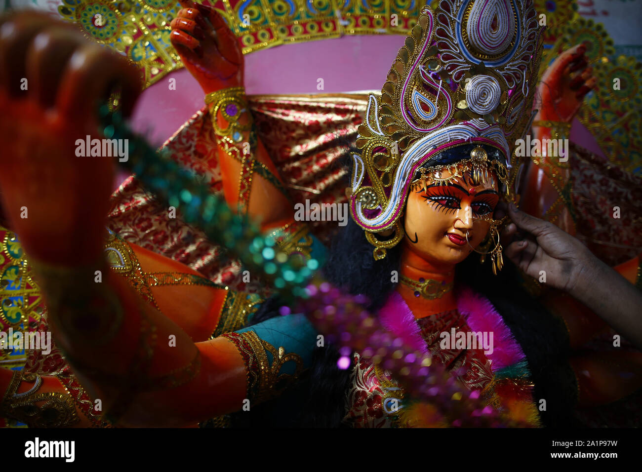 Lalitpur, Nepal. 28th Sep, 2019. An artist giving finishing touches on ...