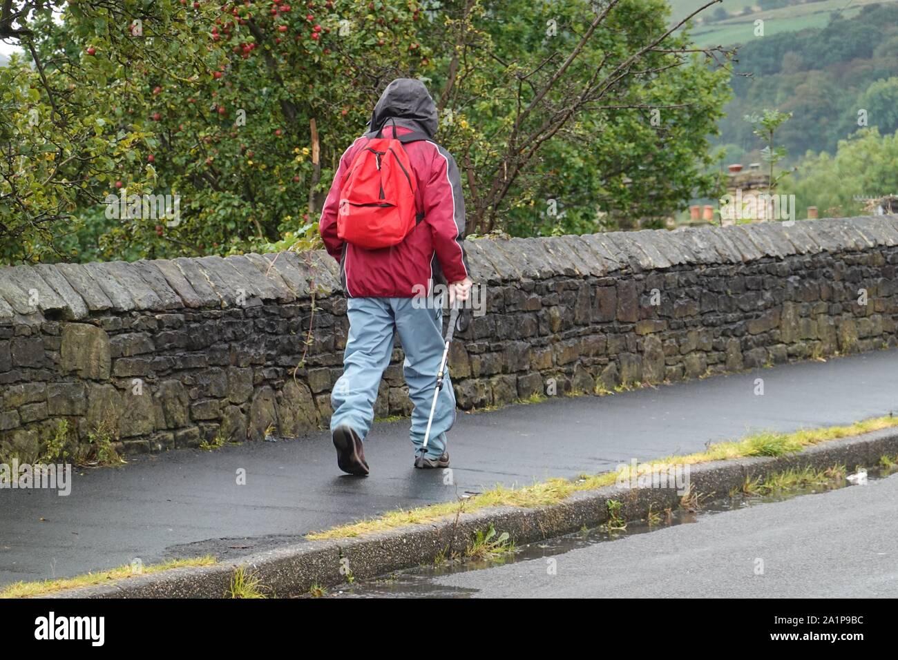 A man walks along Spring Bank in New Mills, High Peak, Derbyshire Stock ...