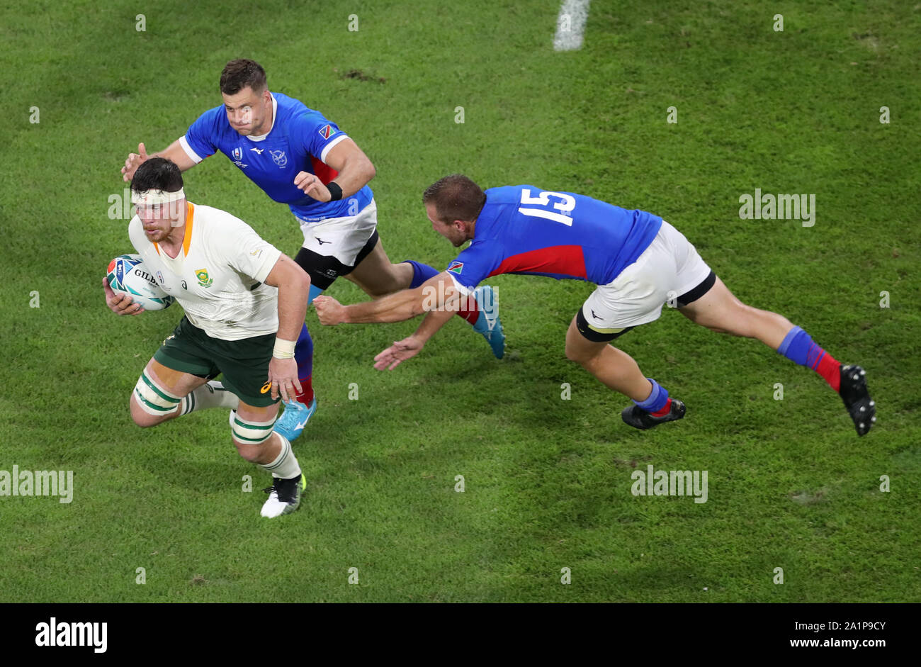 South Africa's Francois Louw is tackled by Namibia's JC Greyling and ...