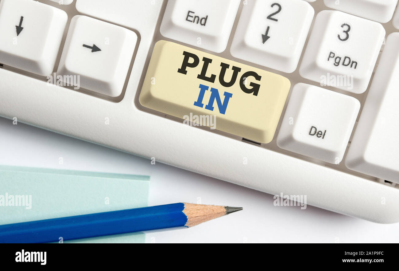 Writing note showing Plug In. Business concept for putting device into ...