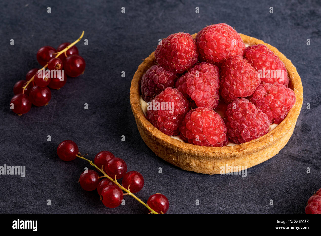 raspberry pie on black stone background Stock Photo - Alamy