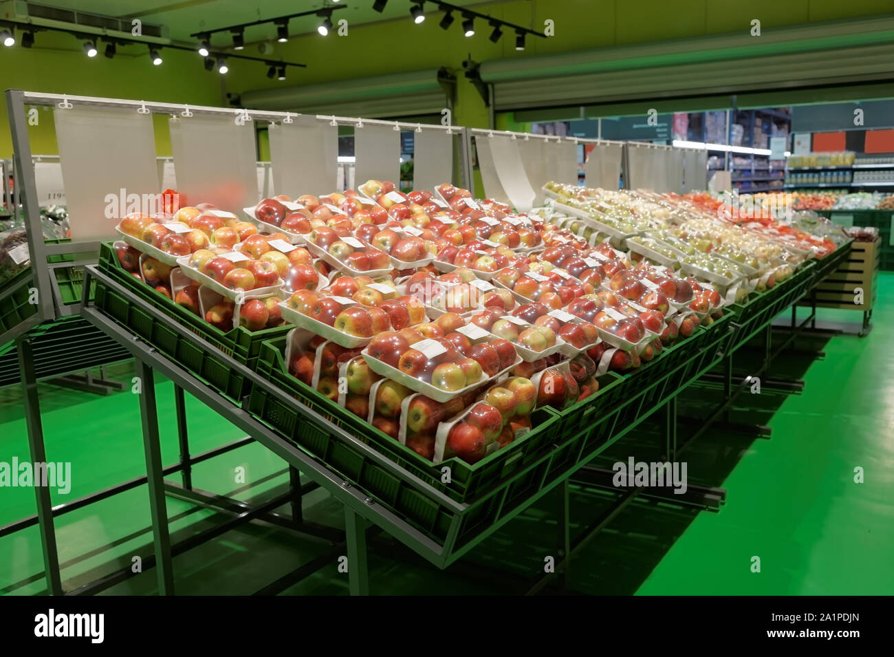 Apples in plastic packs, big supermarket store Stock Photo - Alamy