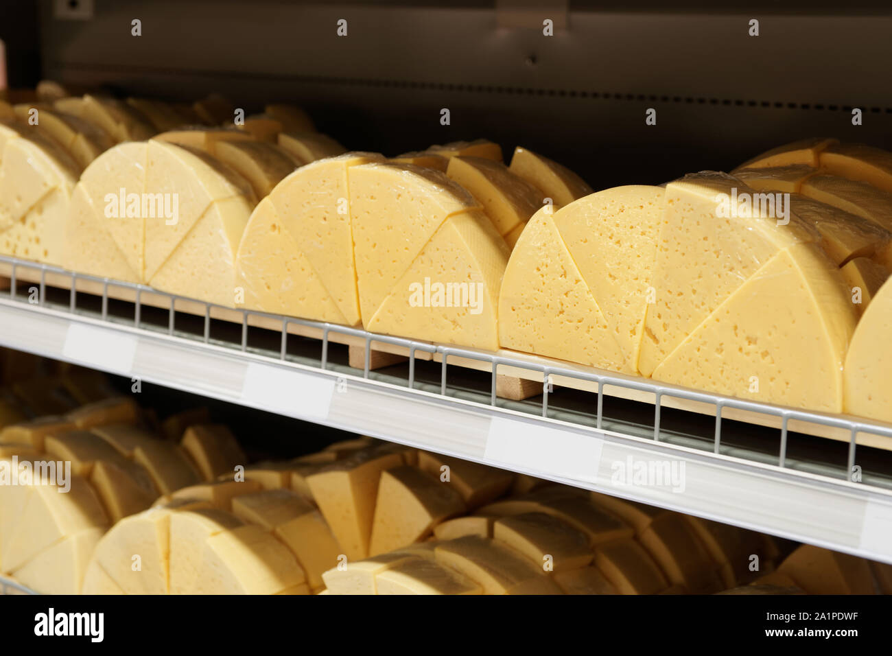 Sold by weight plain cheap cheese on supermarket shelf Stock Photo - Alamy