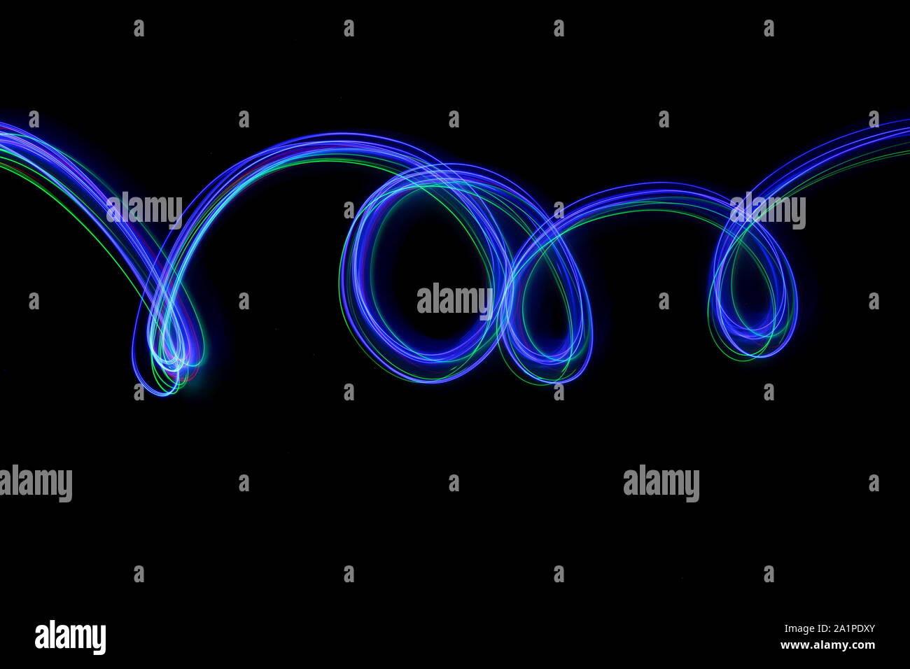 Long exposure photograph of neon colour in an abstract swirl, parallel ...