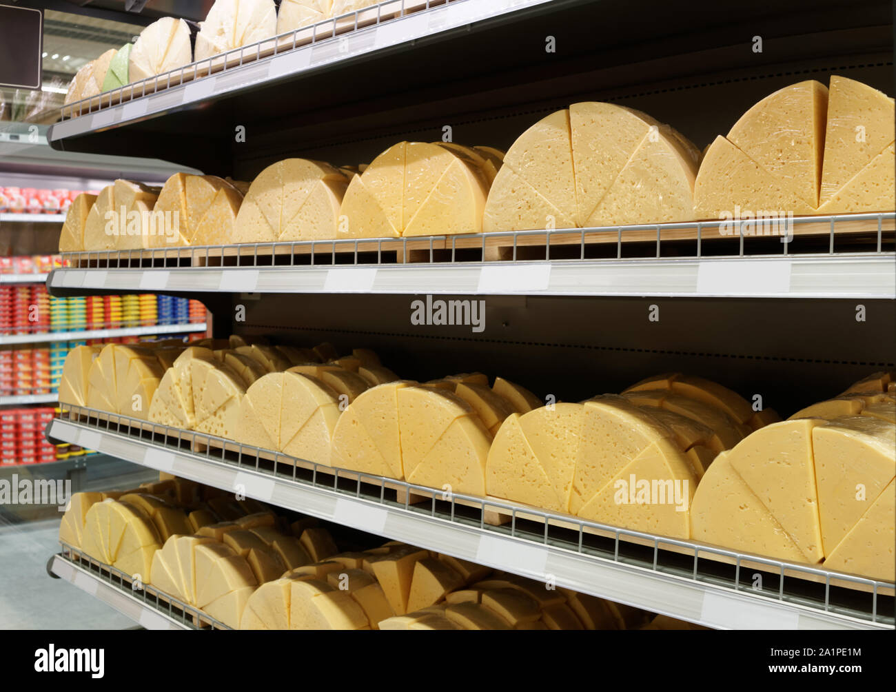 Sold by weight cheap cheese on supermarket shelf Stock Photo - Alamy