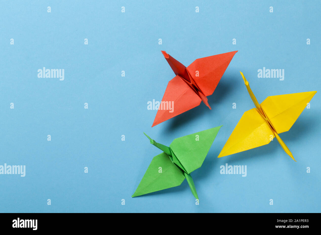 origami paper crane on a blue background Stock Photo - Alamy