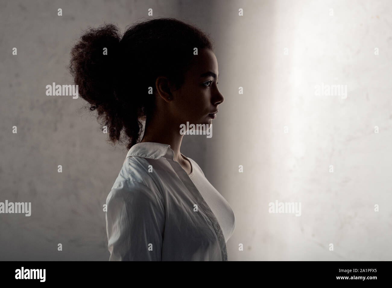 African descent girl wearing white outfit standing isolated on gray ...