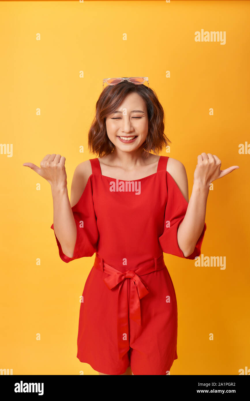 Emotional positive girl posing on yellow background. Good-looking young ...