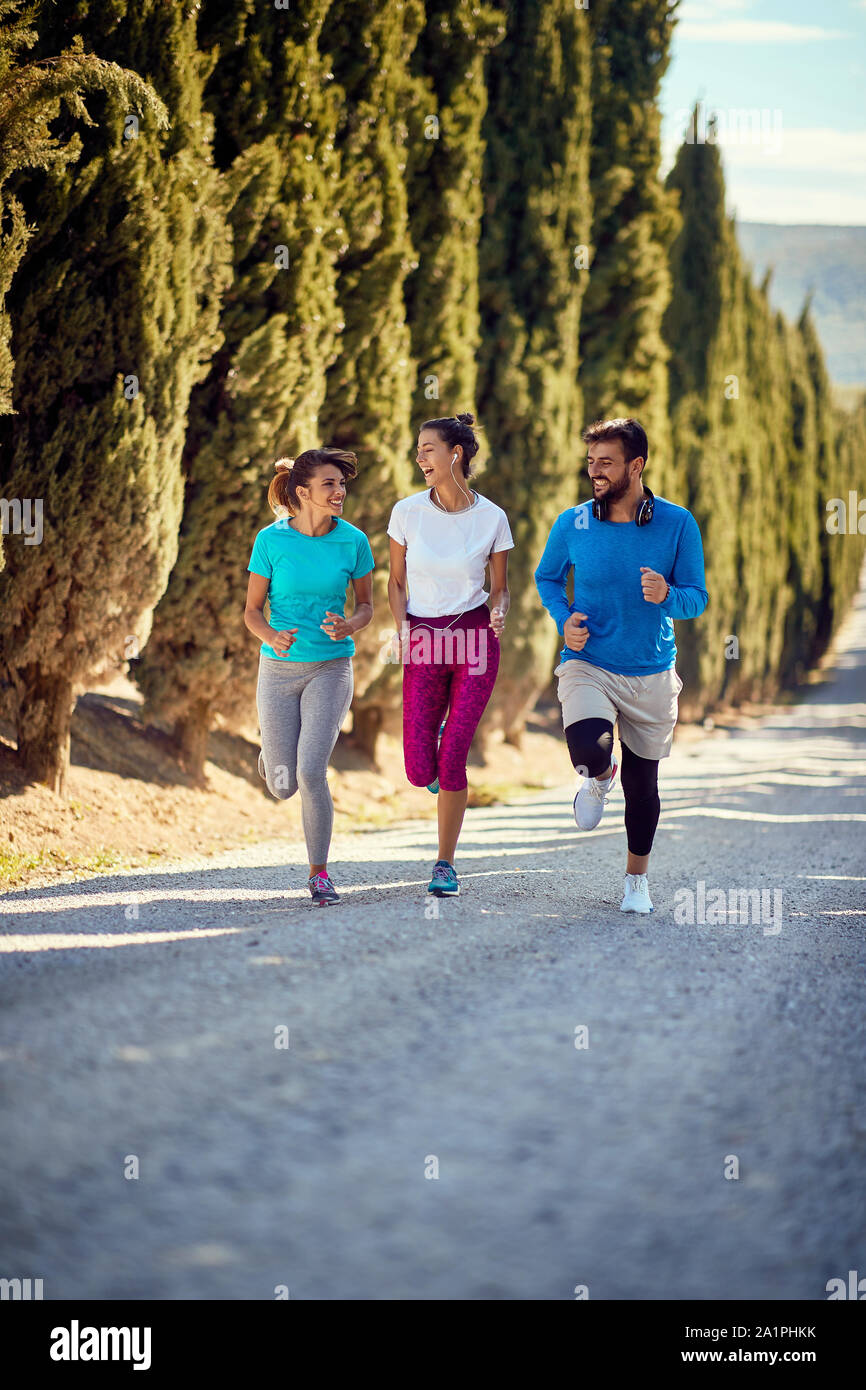 smiling friends enjoying at running together outdoors Stock Photo - Alamy