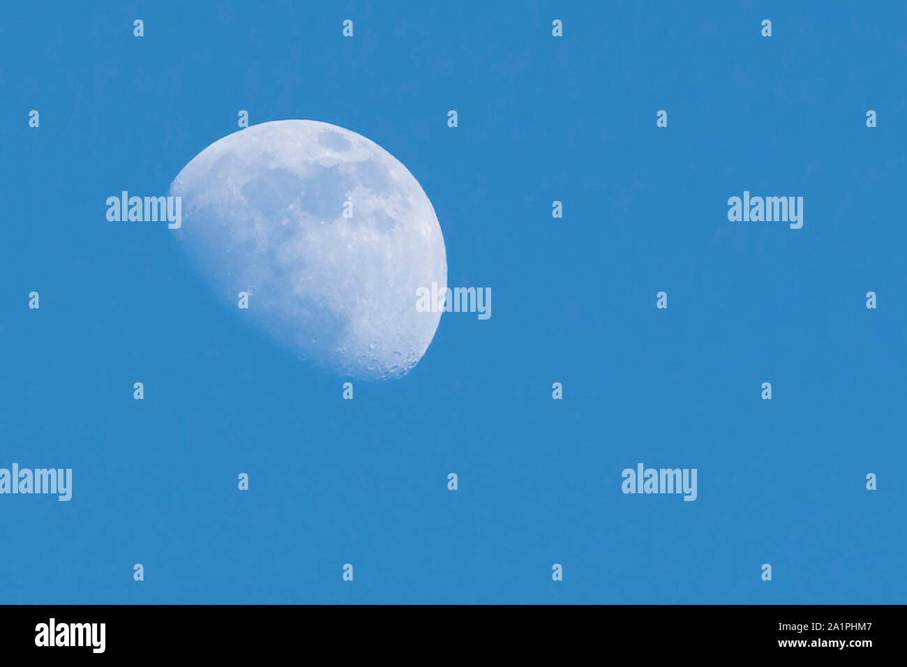 Close up of half moon during daylight with blue sky background, - image ...