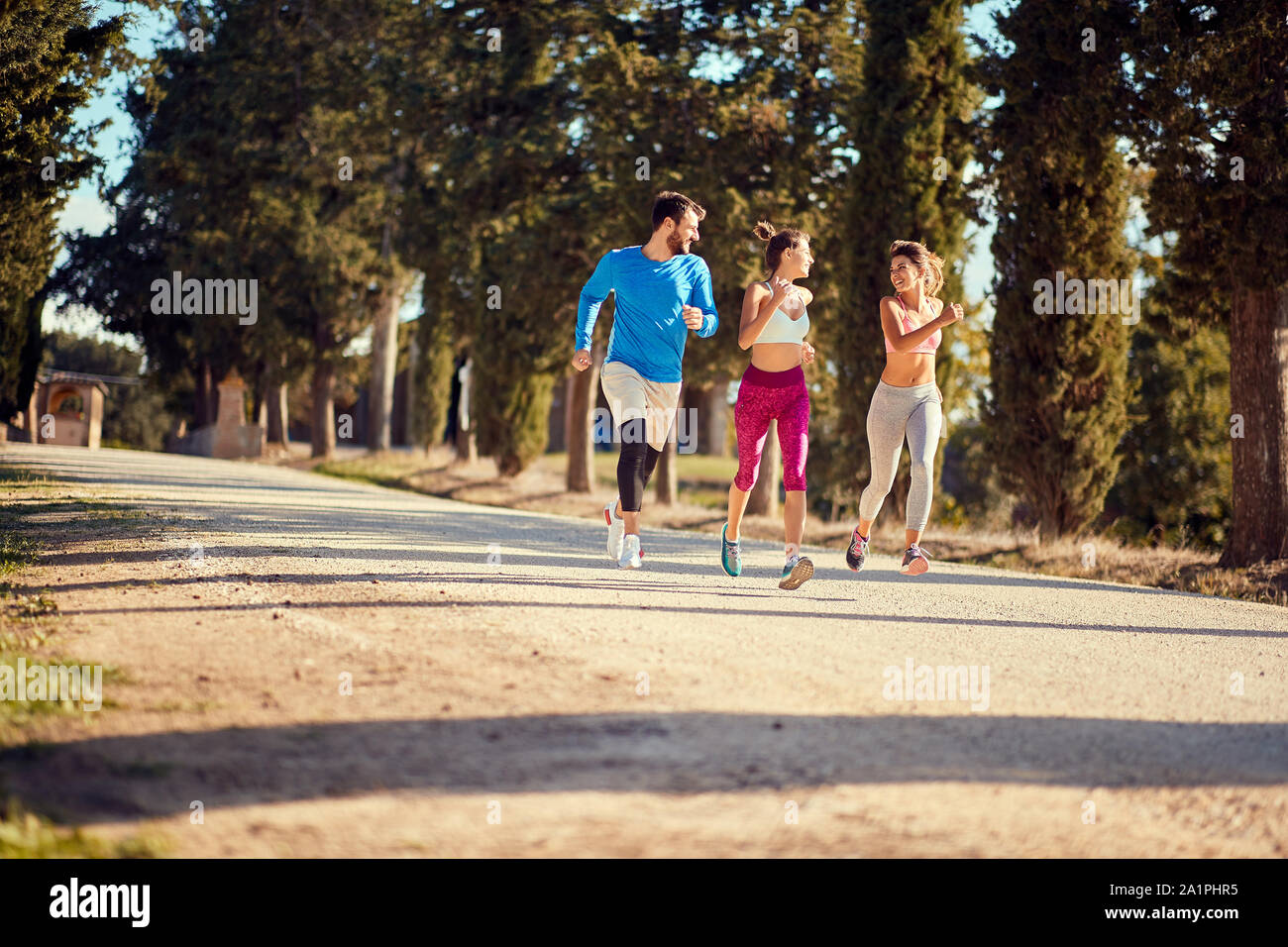 Group of friends jogging in nature hi-res stock photography and images ...