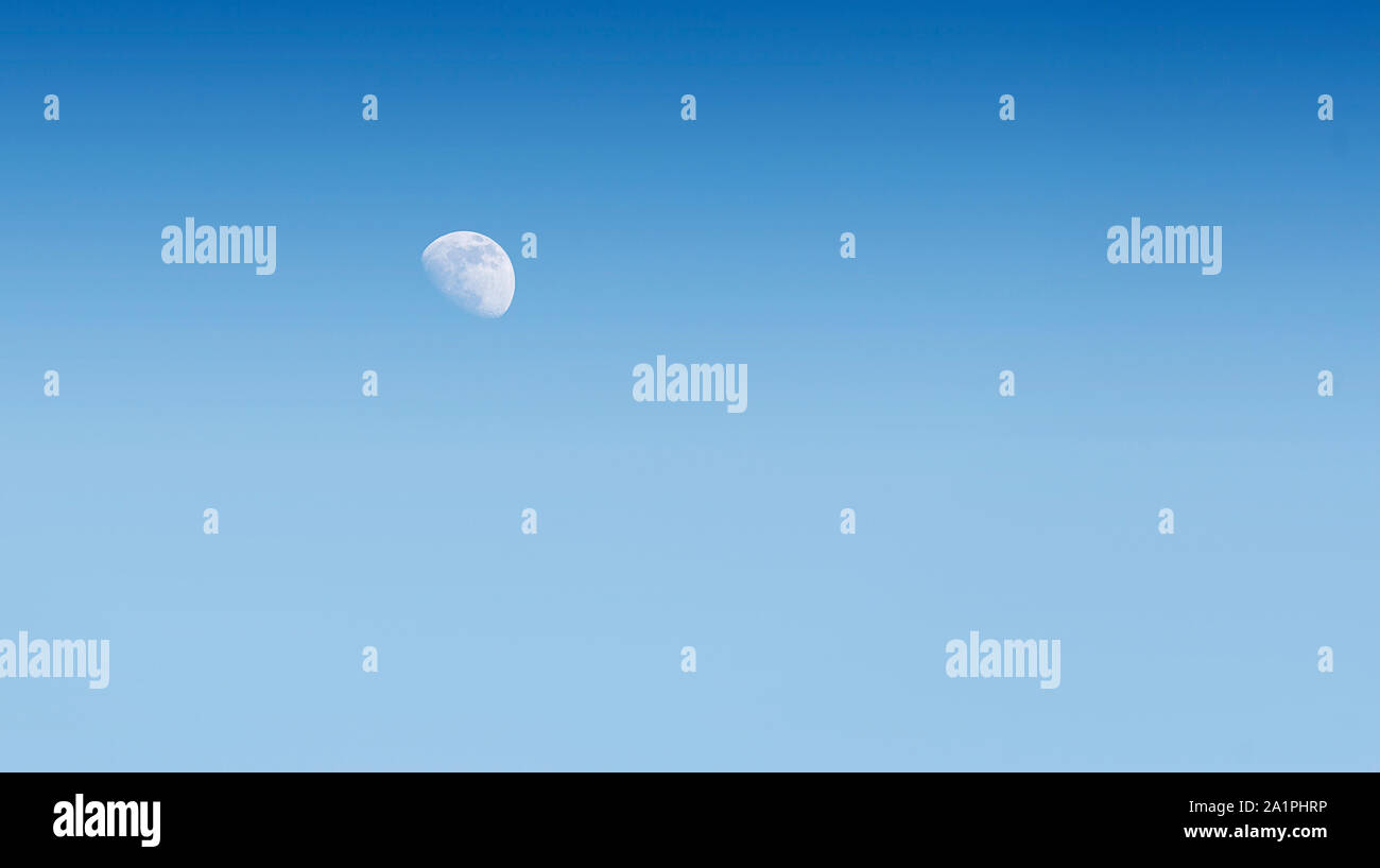 Close up of half moon during daylight with blue sky background, - image ...