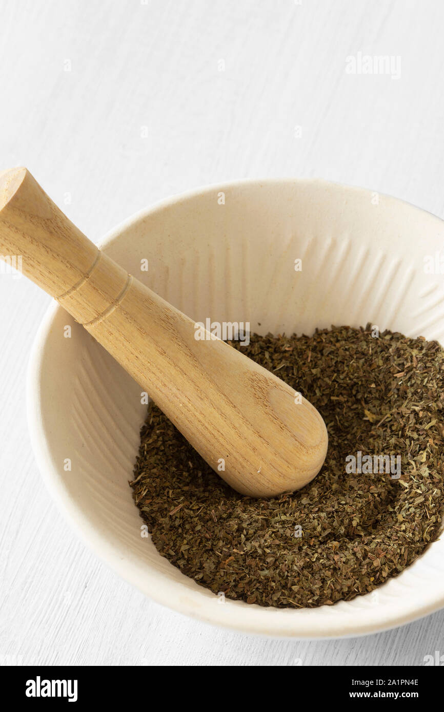 Ground mint in a pestle and mortar on a white wood background Stock ...