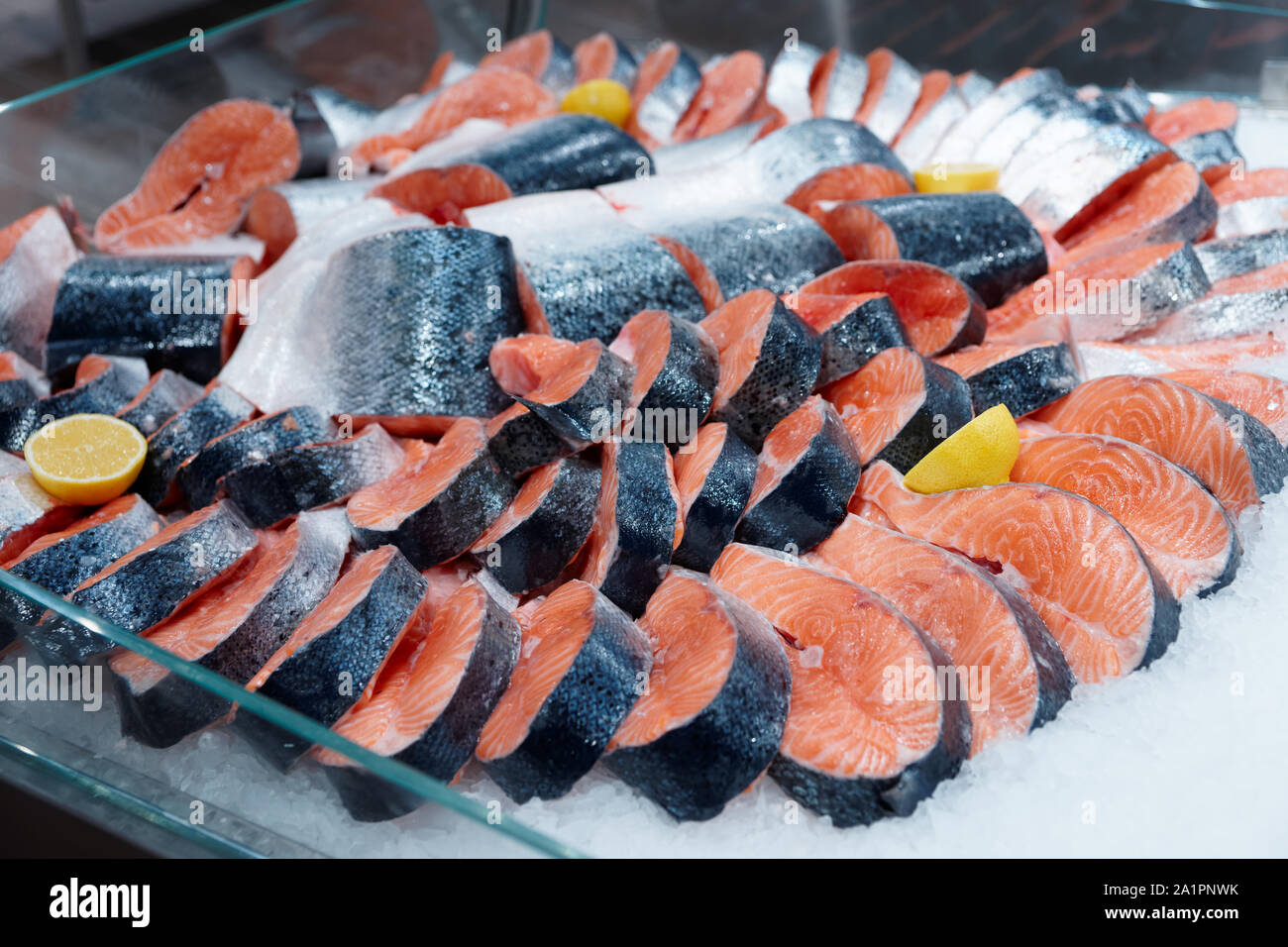 Salmon steaks and fillet on iced food market display Stock Photo - Alamy