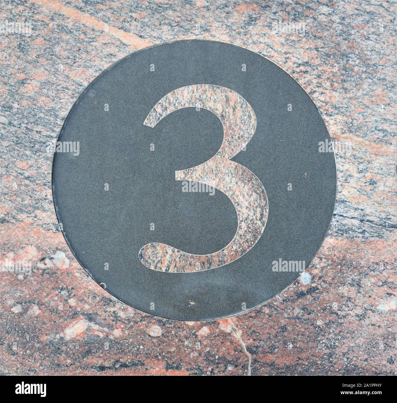 Number three in pink marble inside a circle of black marble shade pink ...