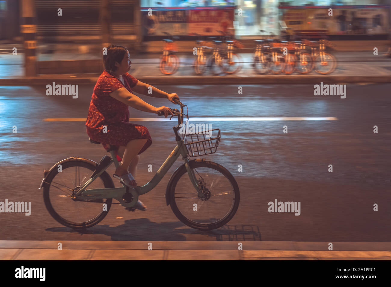 Chinese woman cycling hi-res stock photography and images - Alamy