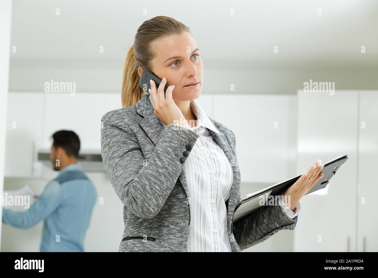 realtor calling someone with her mobile phone Stock Photo - Alamy