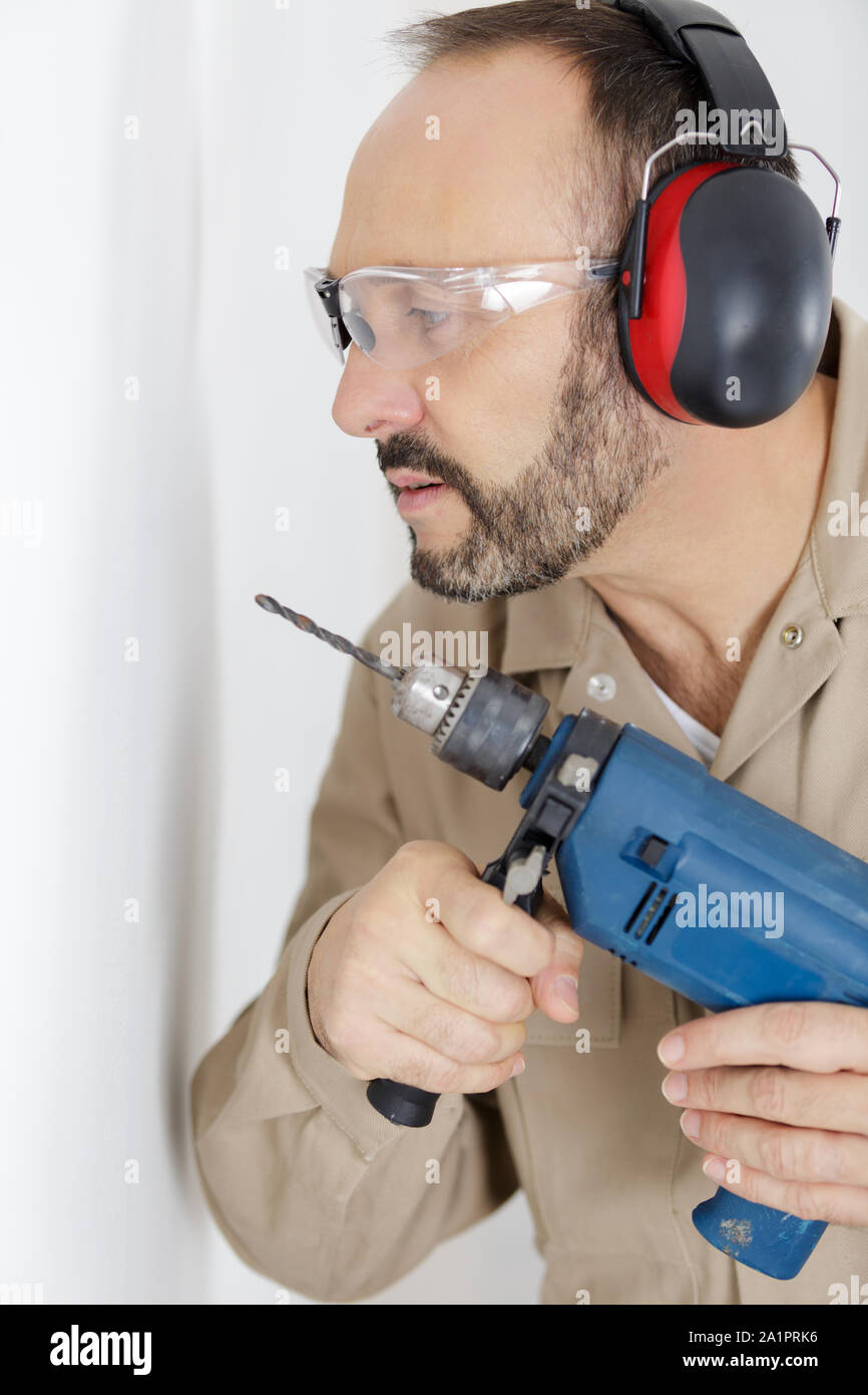 a man drilling the wall Stock Photo - Alamy