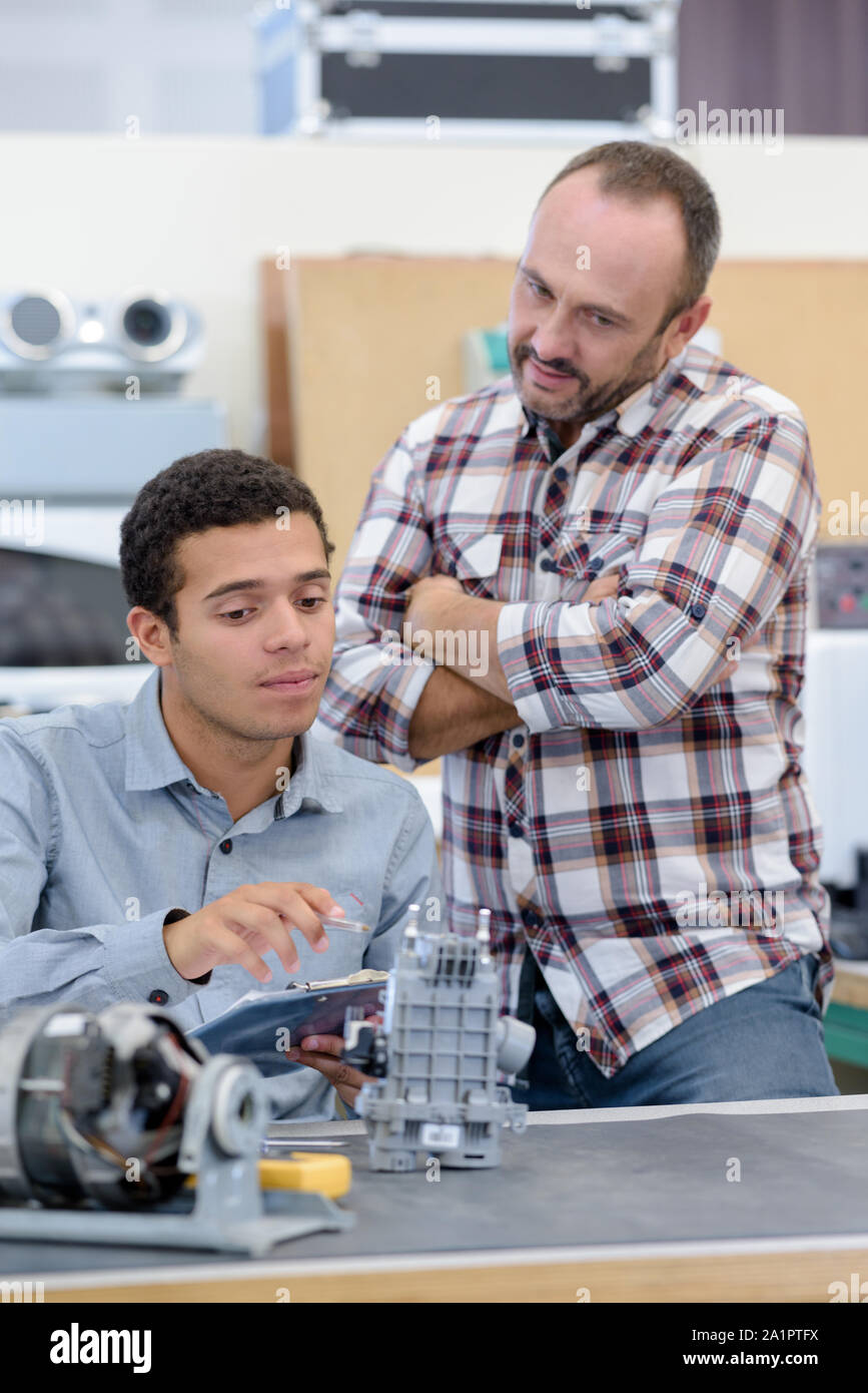 two men working at a factory Stock Photo - Alamy