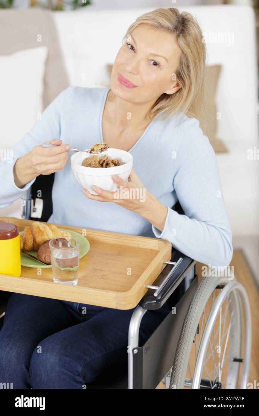 mature woman in wheelchair eating healthy Stock Photo - Alamy