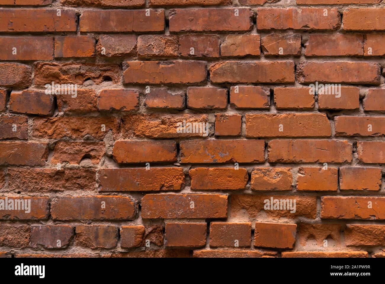 background old brick wall of jagged red clay bricks Stock Photo - Alamy