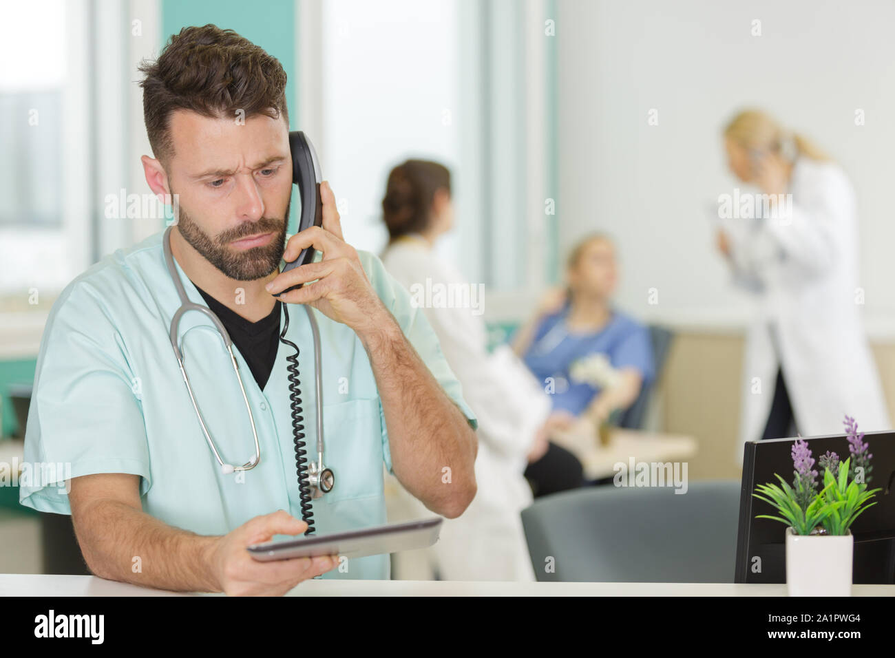 Tired doctor on phone hi-res stock photography and images - Alamy