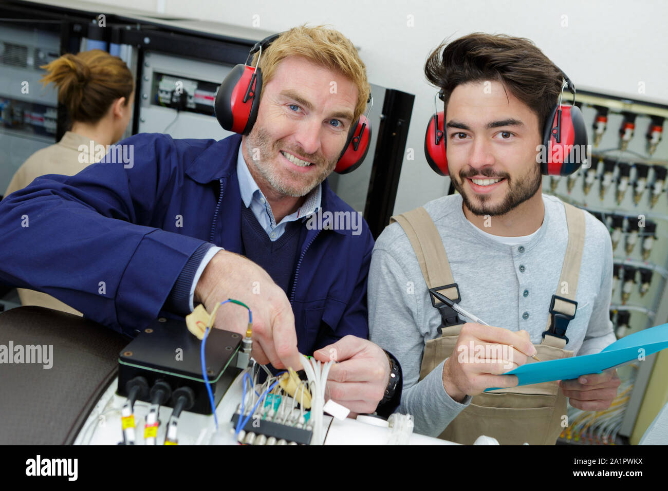 2 electronic engineers looking at the camera Stock Photo - Alamy