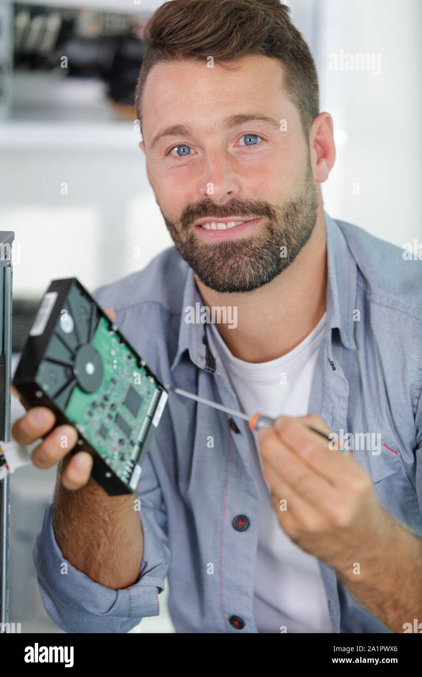 happy man screwing the hard drive Stock Photo - Alamy