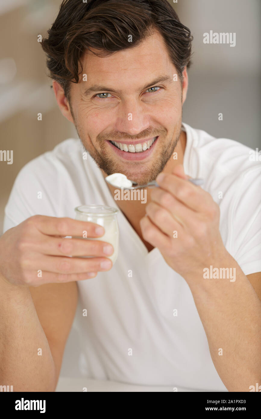 healthy eating man yogurt in the kitchen Stock Photo - Alamy