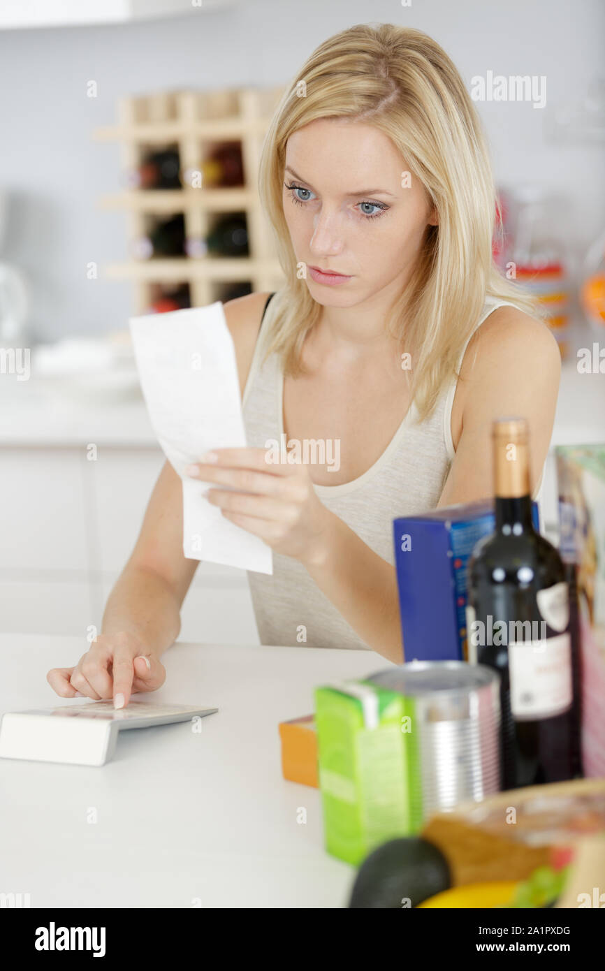 woman checking a long receipt Stock Photo - Alamy