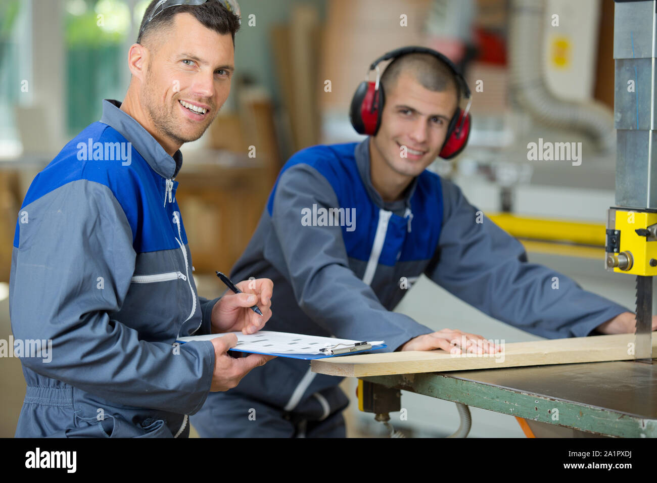 two happy workers with construction materials Stock Photo - Alamy