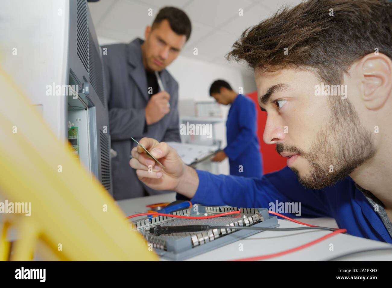 man repairing a printer at work Stock Photo - Alamy
