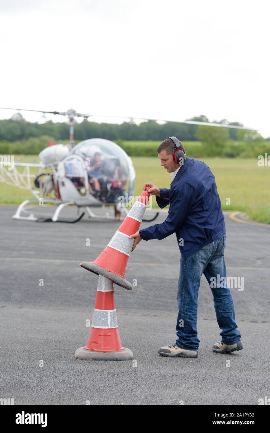 man putting out safety cones at an airfield Stock Photo - Alamy