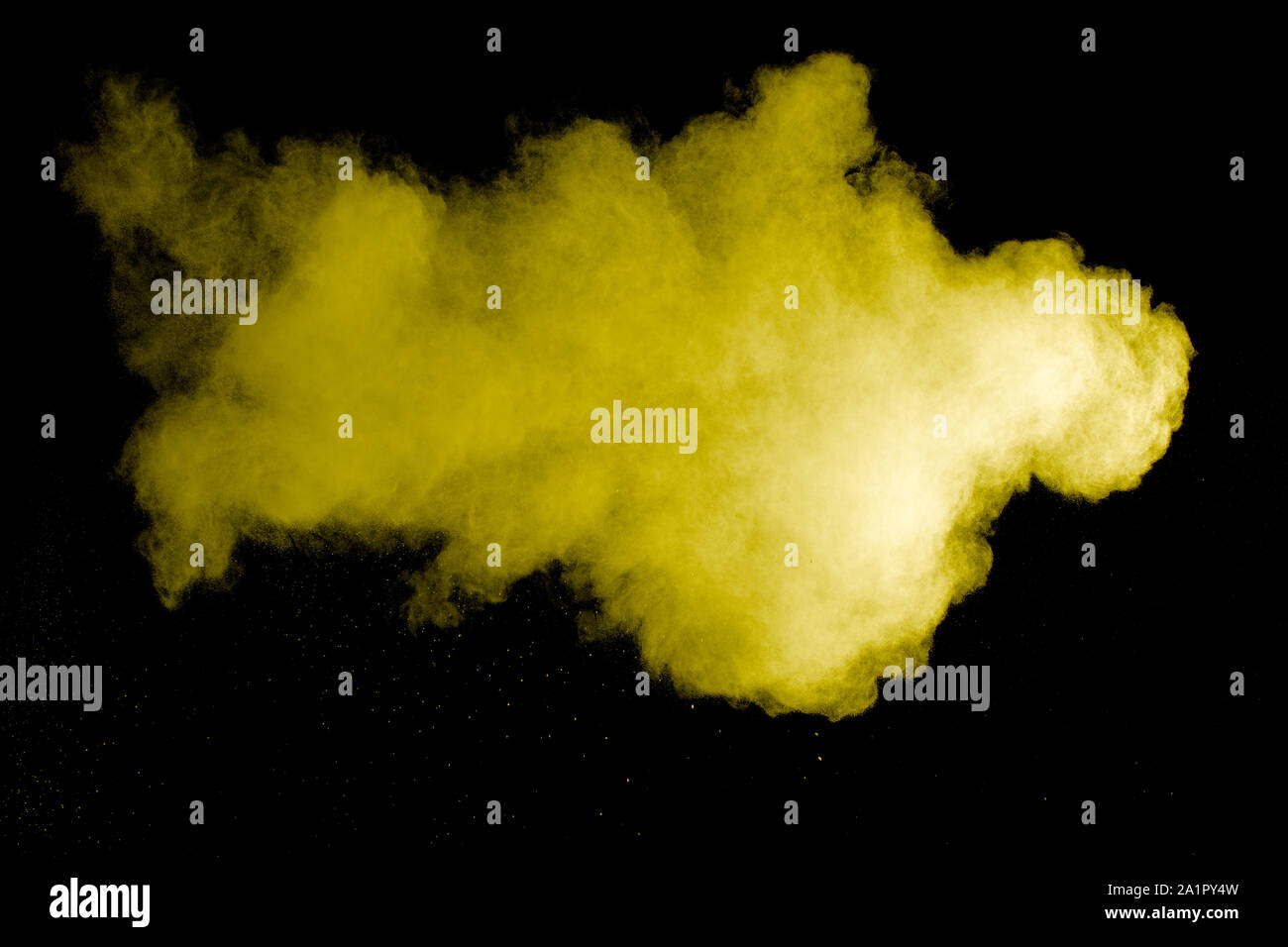 Yellow color powder explosion on black background Stock Photo - Alamy
