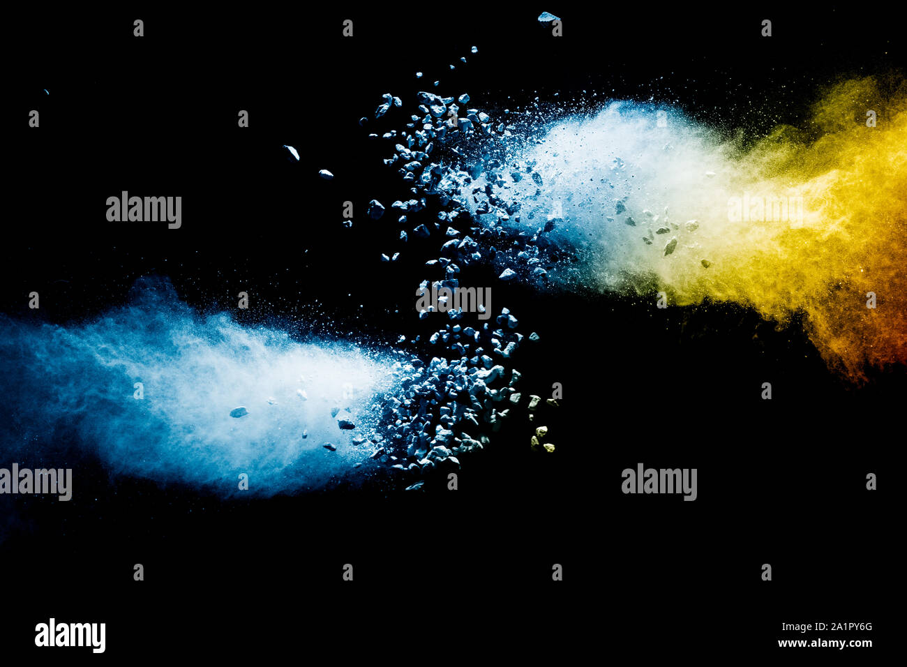 Split debris of stone exploding with blue powder against black ...
