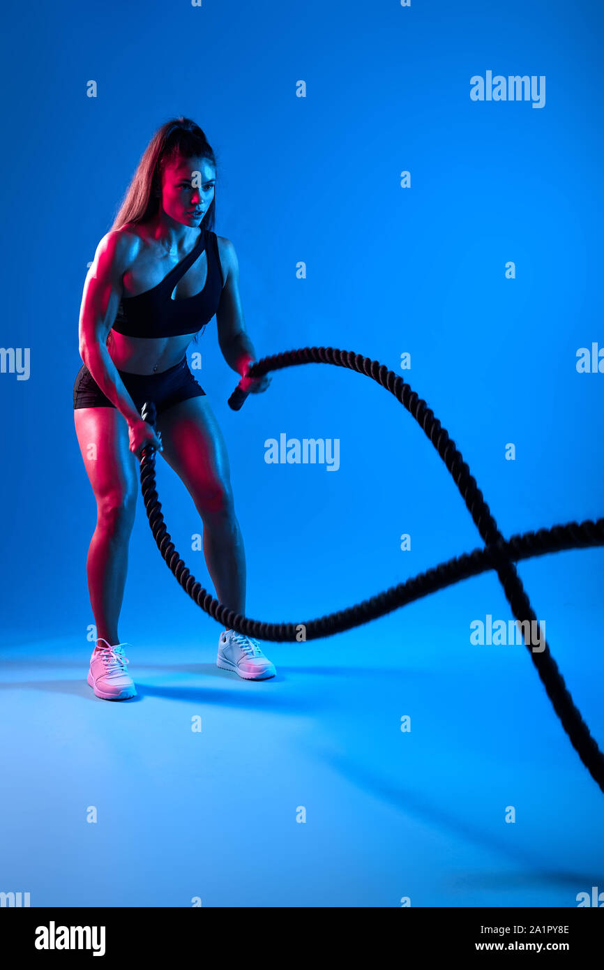 beautiful strong woman keeping fit at gym, full length photo.isolated ...