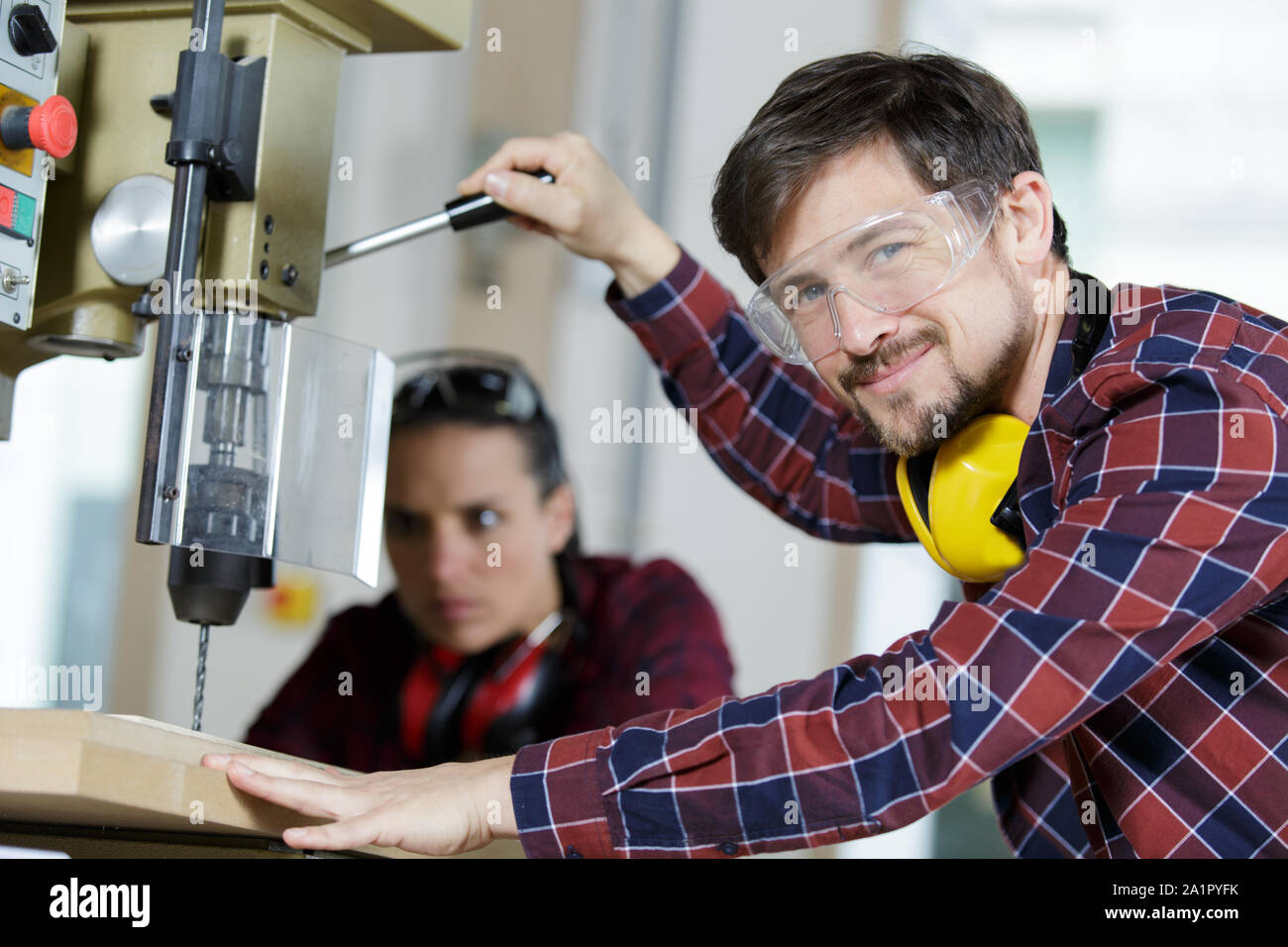 happy man working with electrical screwdriver on plywood indoors Stock ...