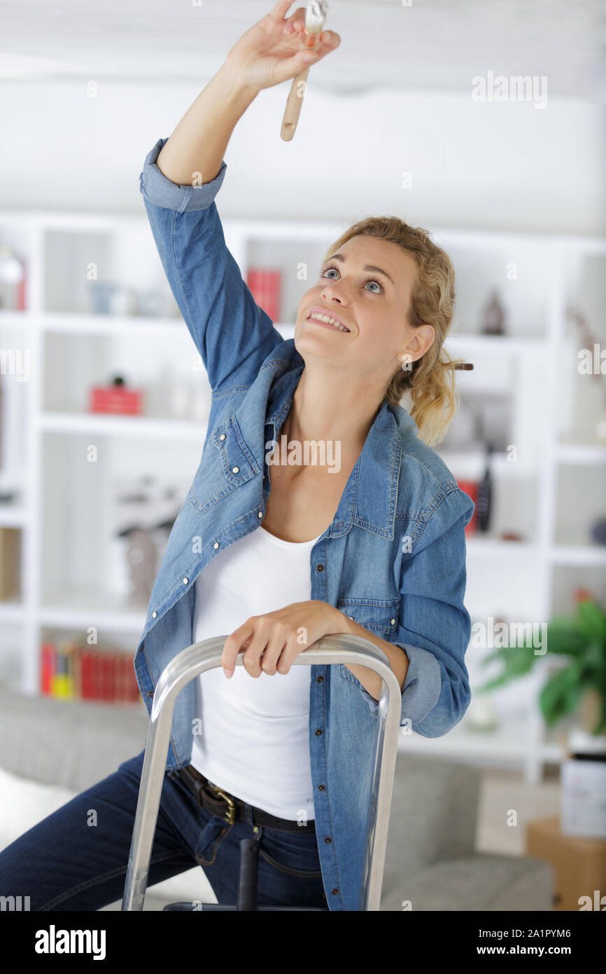 a female decorator painting ceiling Stock Photo - Alamy