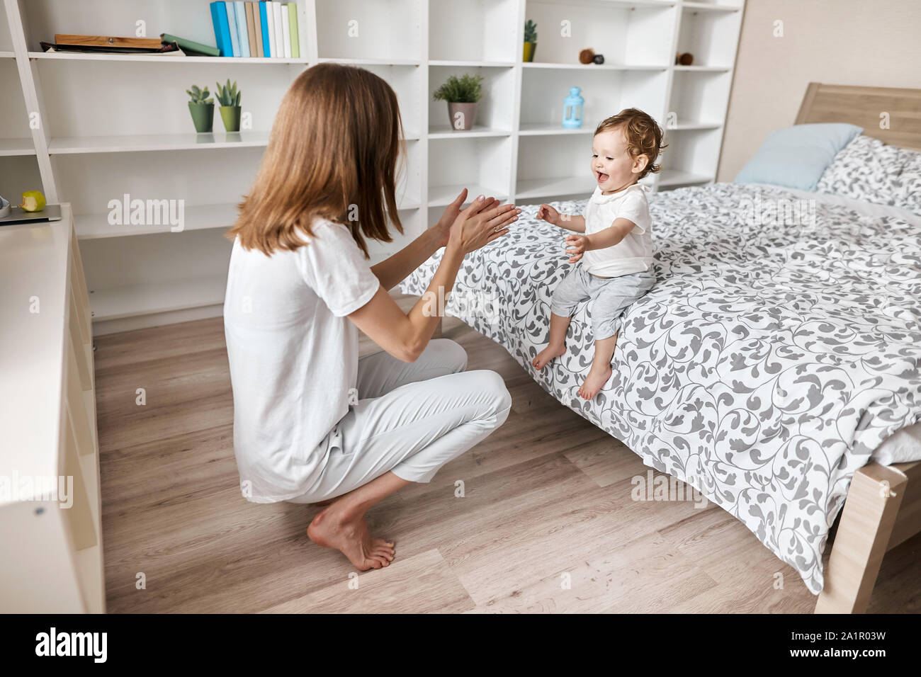 mommy teaching her kid to clap hands, free time, spare time, happiness ...