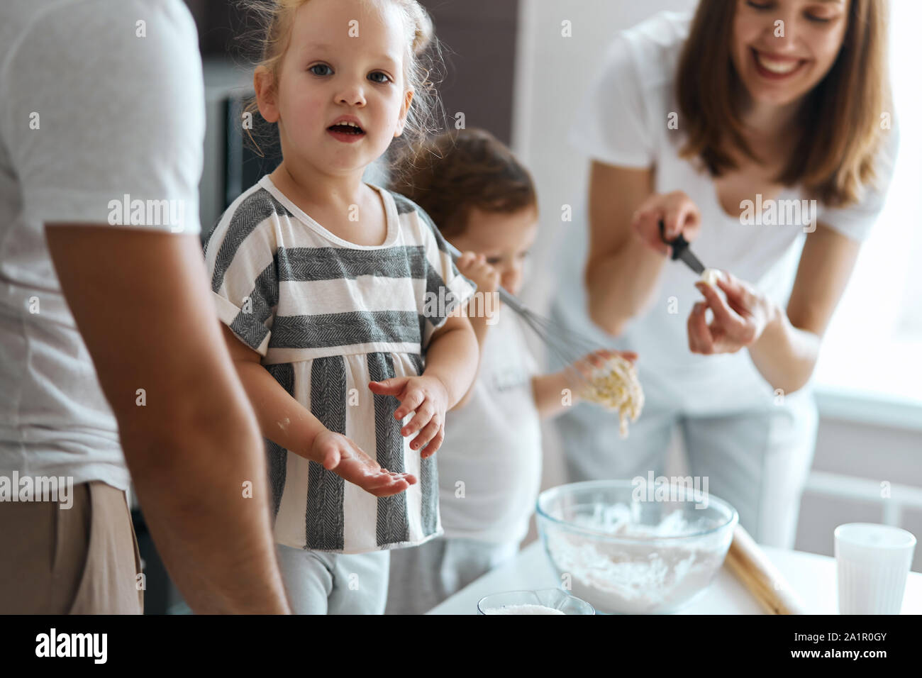 Girl standing behind table hi-res stock photography and images - Alamy