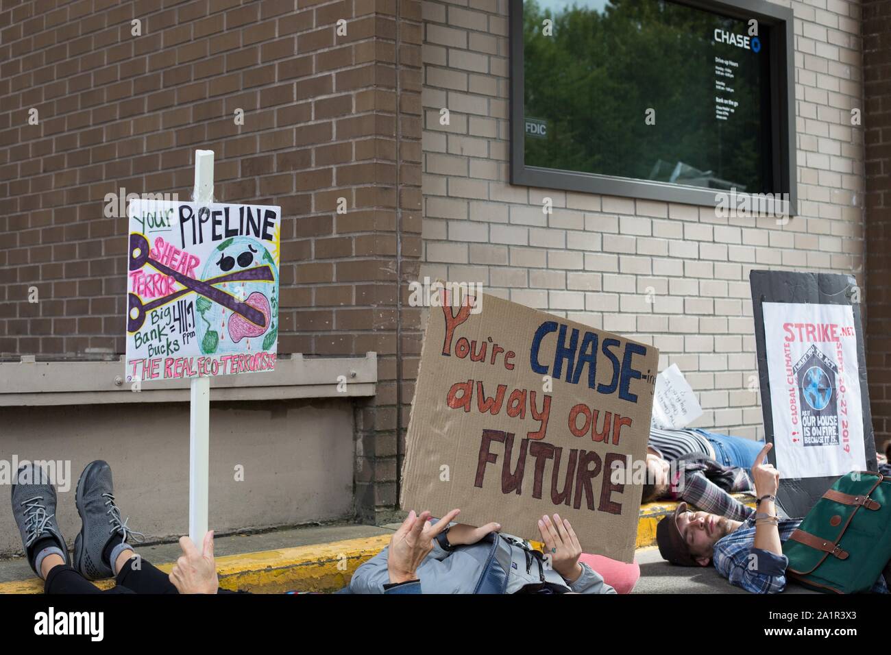 Climate activists perform a die-in at Chase Bank in Eugene, Oregon, USA ...