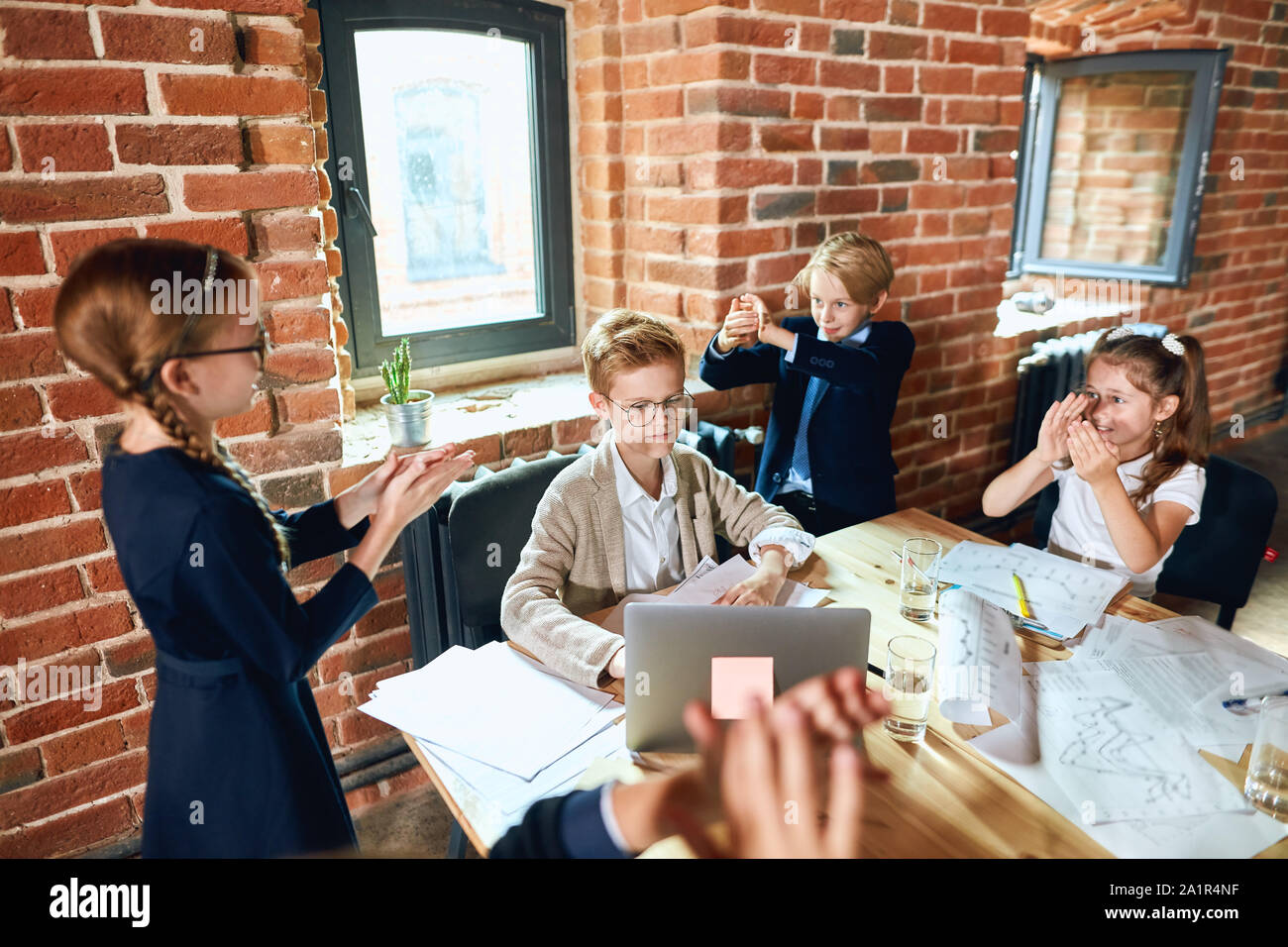 happy boys and girls rejoicing at successful business, promotion ...