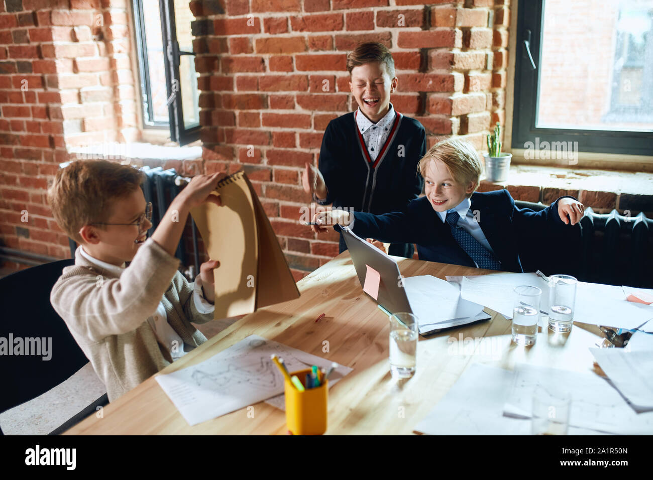 positive team laughing at project, having fun during the meeting. close ...