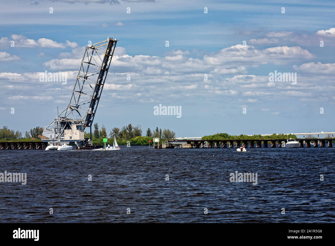 3 boats motoring through open bridge, 2 boats anchored, recreation ...
