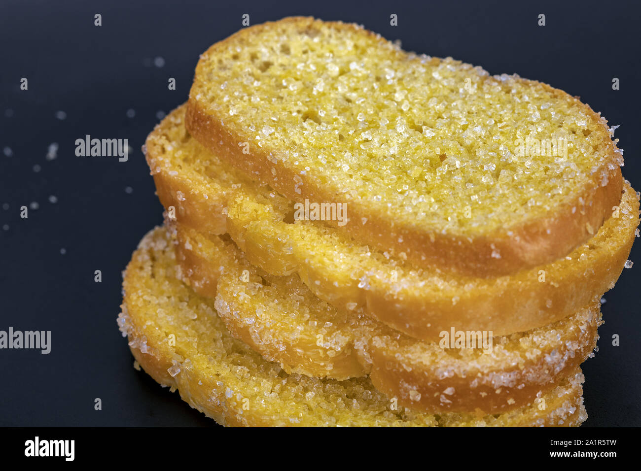 Delicious crisp sliced butter toast on black plate Stock Photo - Alamy